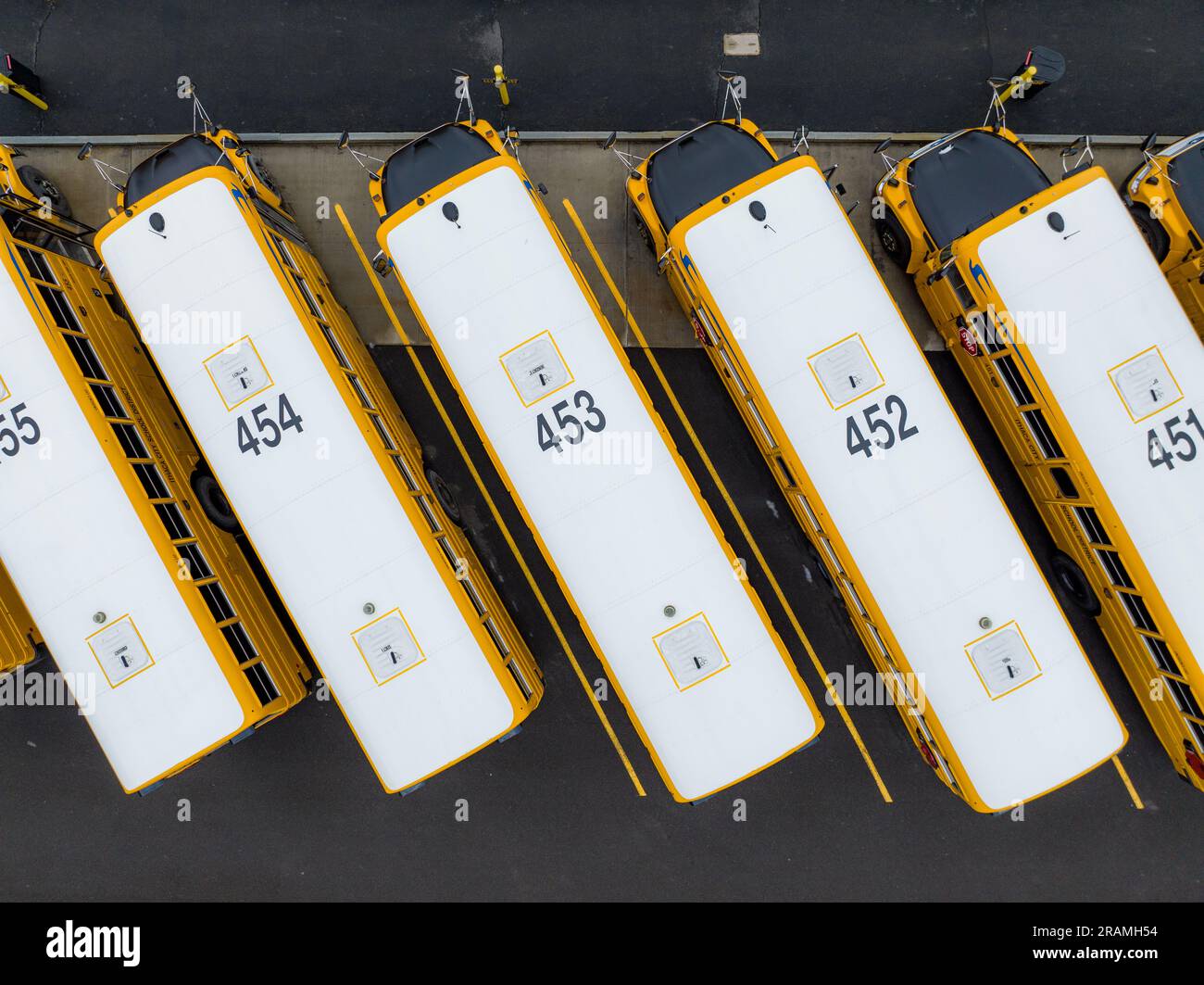 Aerial view of yellow school buses in a concrete parking lot Stock ...