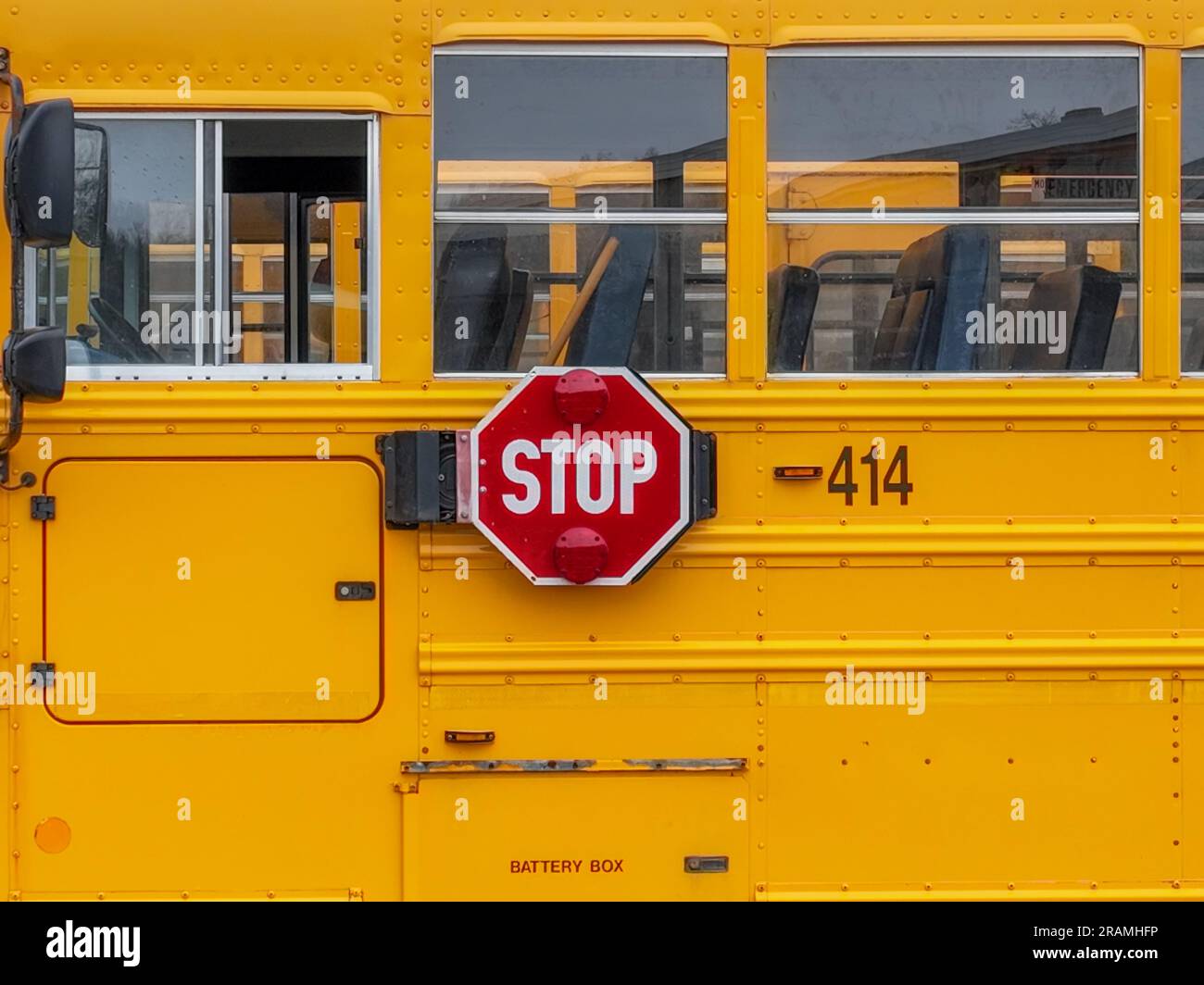View of the drivers side of a yellow school bus in a parking lot Stock ...