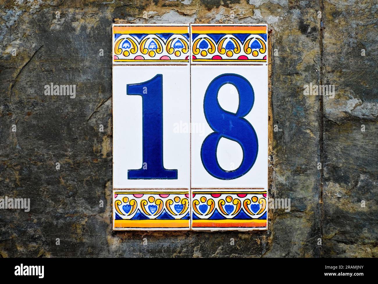 18, number eighteen on tiles on a stone wall Stock Photo - Alamy