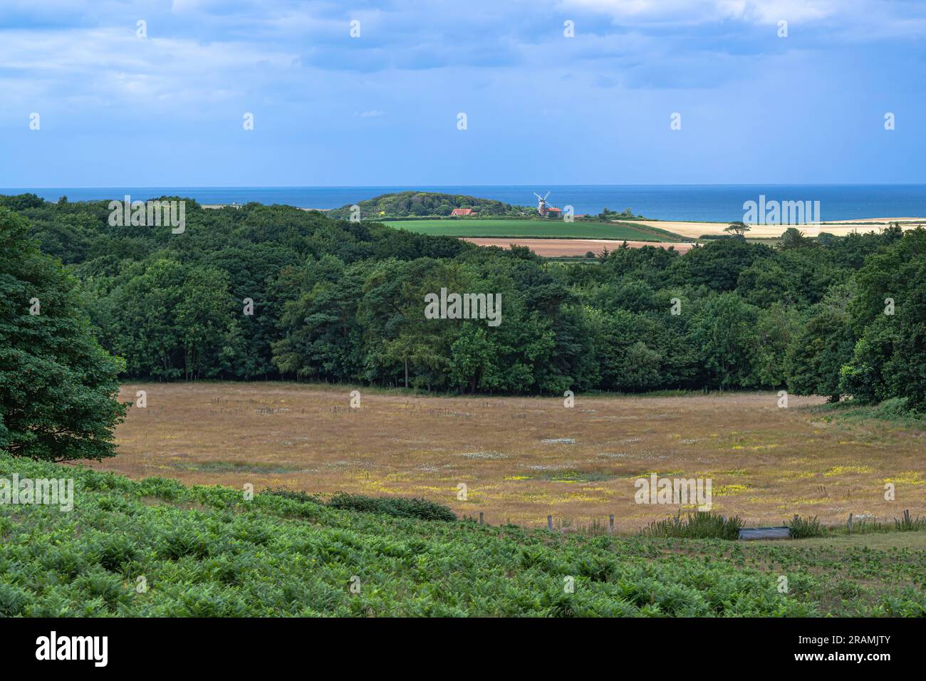 A distant view looking over towards the sea and Weybourne Windmill ...