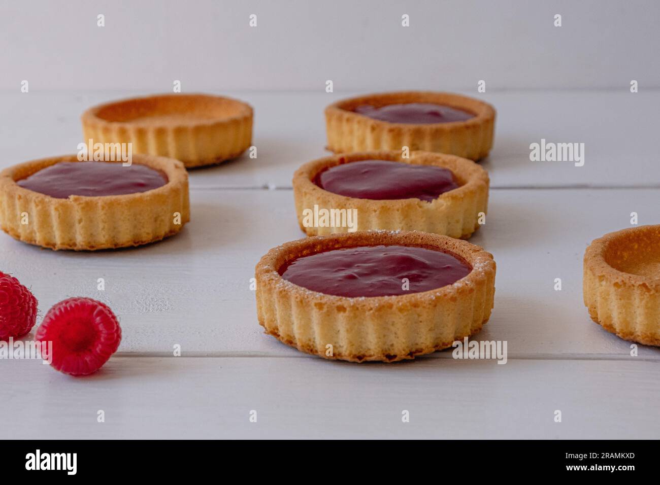 Small tartlets with raspberry filling Stock Photo - Alamy