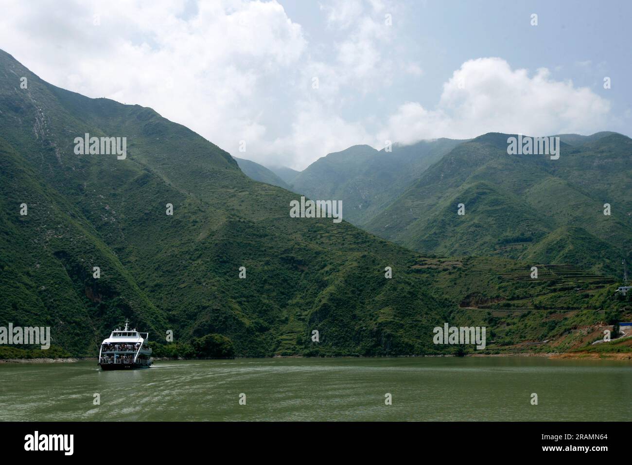 A cruise boat travels the Daning River through the Dragon Gate Gorge of ...