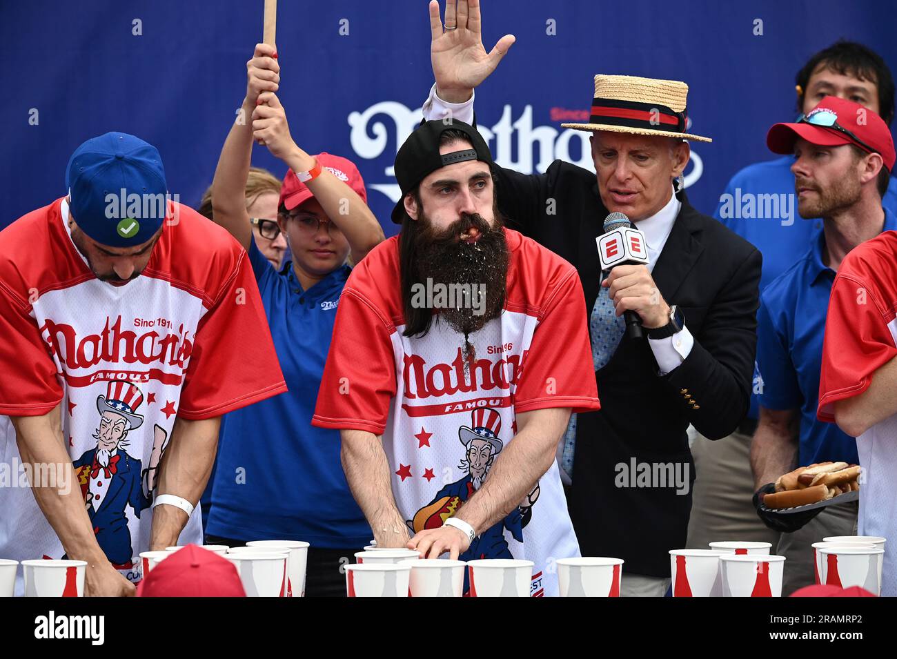 New York, USA. 04th July, 2023. Competitive eater Adam Moran (c) from ...