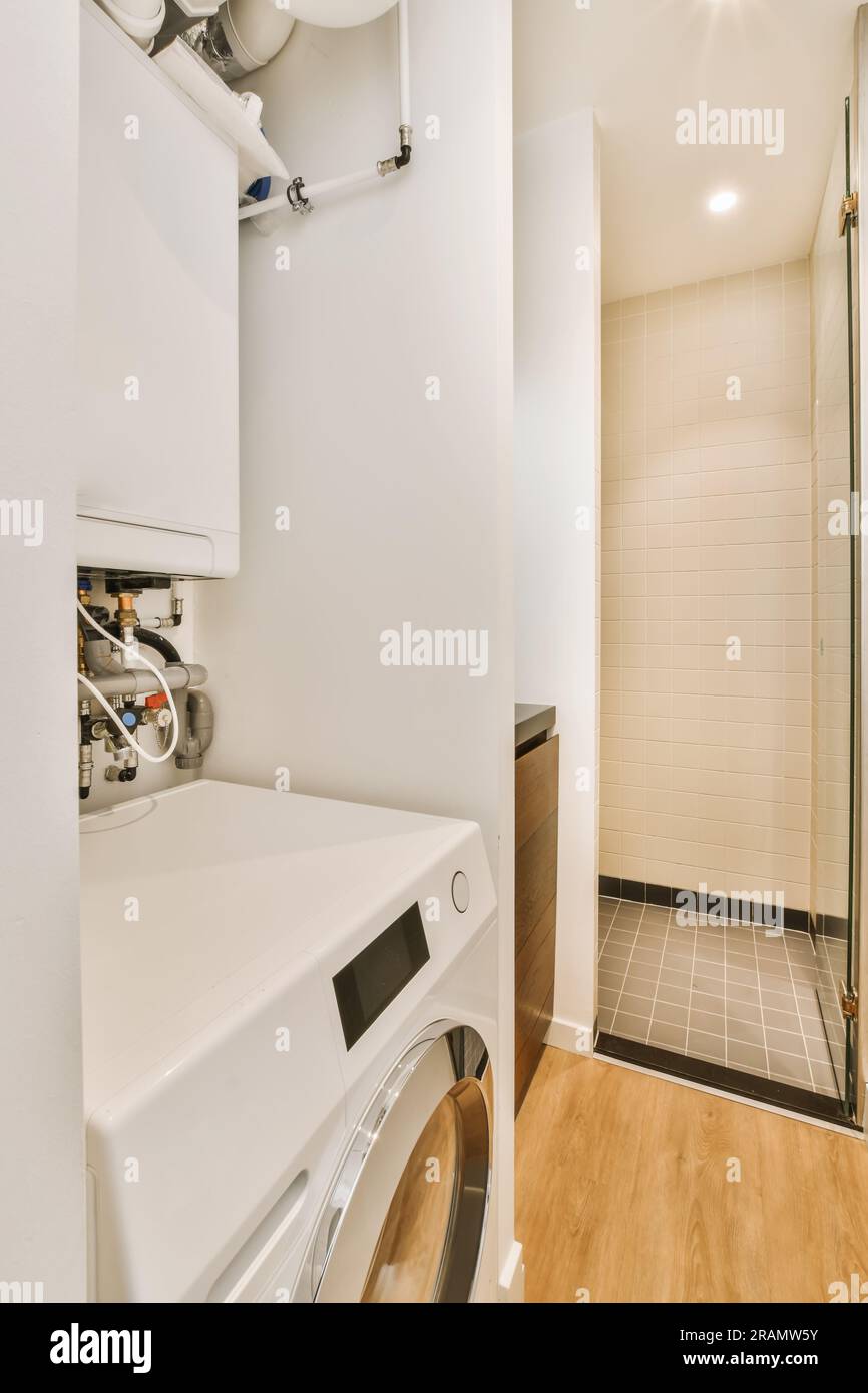 a laundry room with a washer and dryer next to the shower stall in the ...