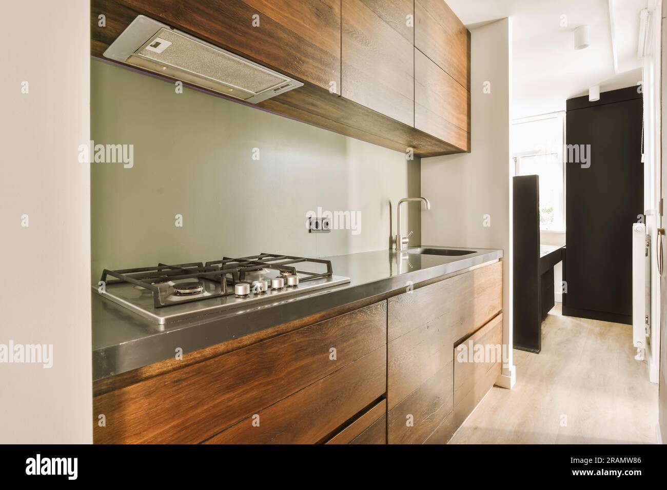 a modern kitchen with wood cabinets and black countertops on the wall ...