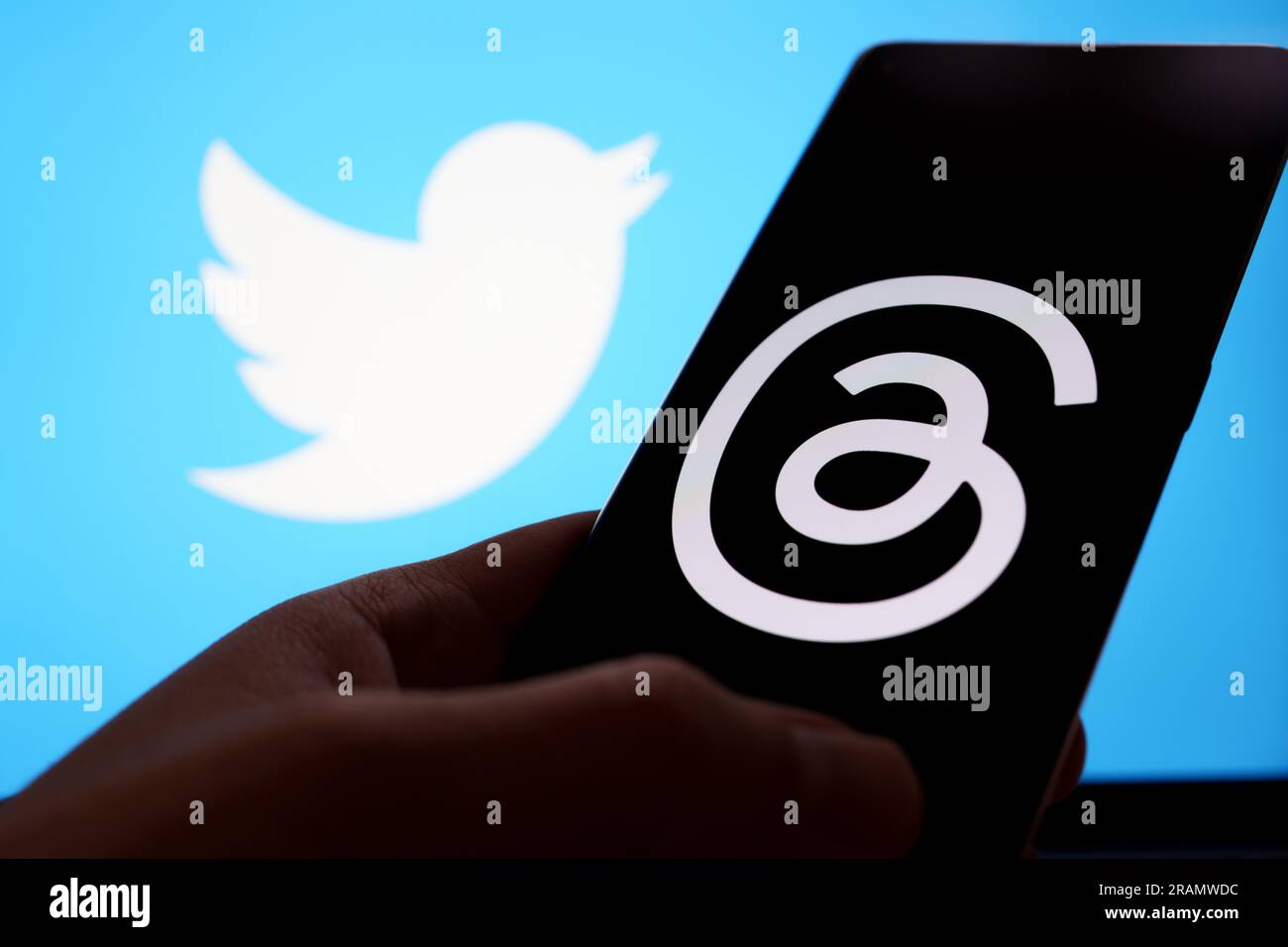 Threads vs Twitter concept. Threads app logo seen on screen of ...