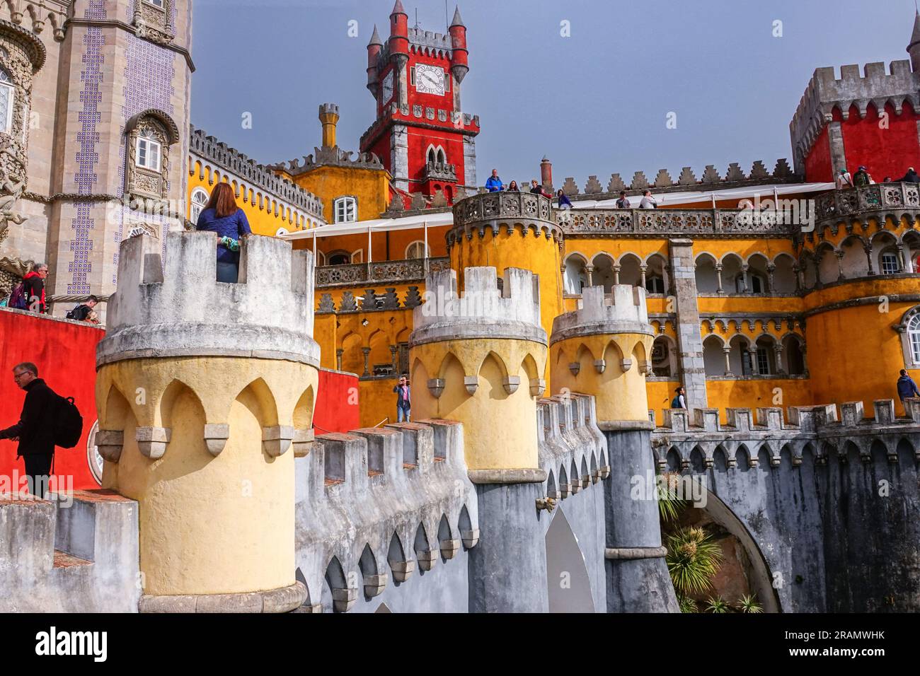 Colorful facade with the royal quarters and red clock tower at the Pena ...