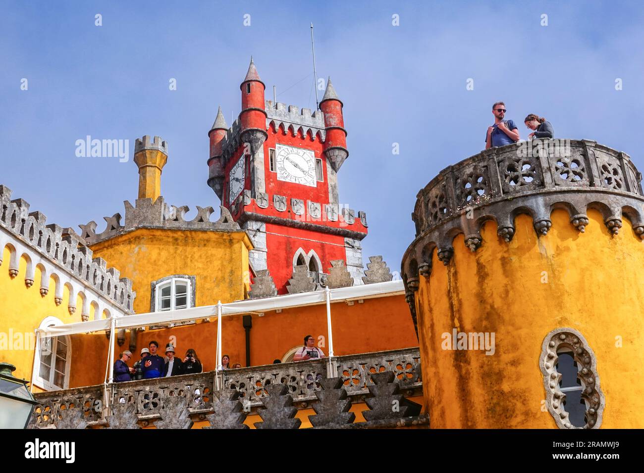 Colorful facade with the royal quarters and red clock tower at the Pena ...
