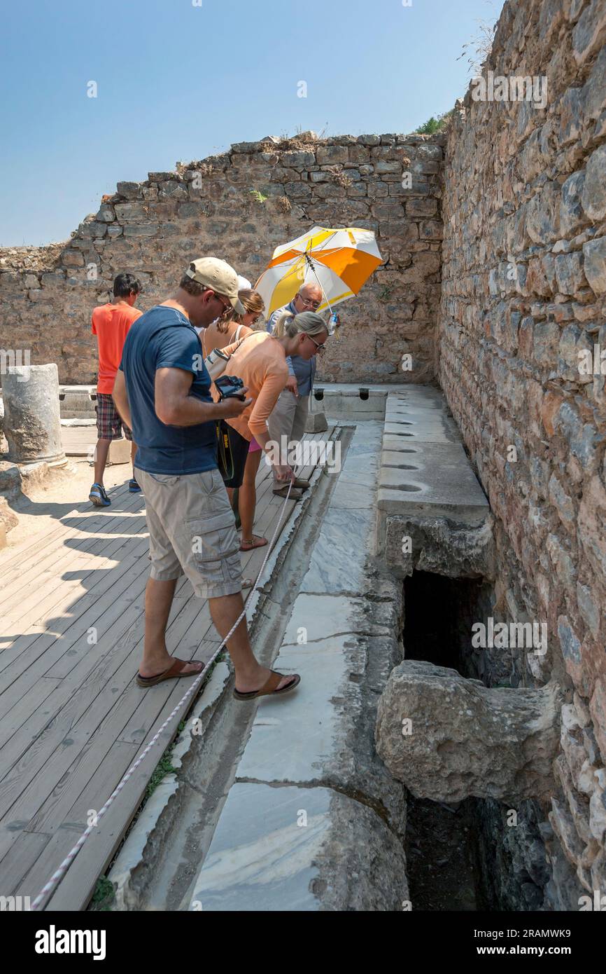 Visitors to the ancient site of Ephesus at Selcuk in Turkiye inspect ...