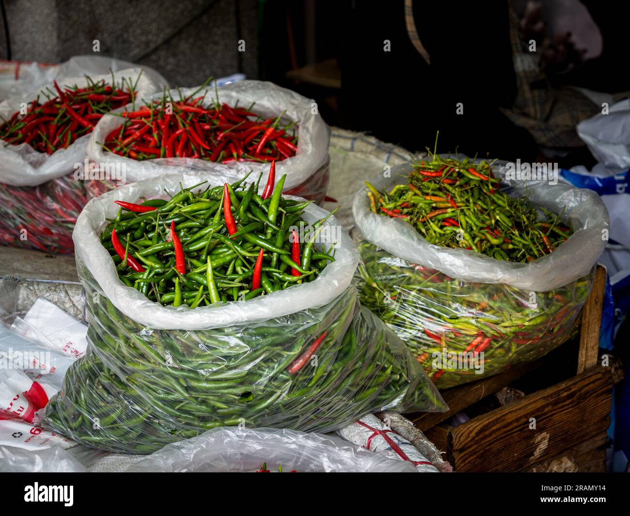 In a vibrant street market of Bangkok, Thailand, sizable sacks brim ...