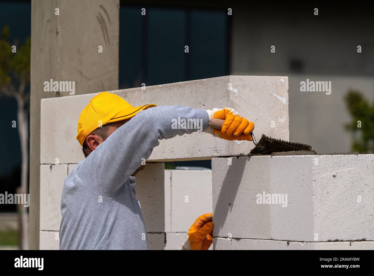 The bricklayer is working. Building a wall of aerated concrete Stock ...