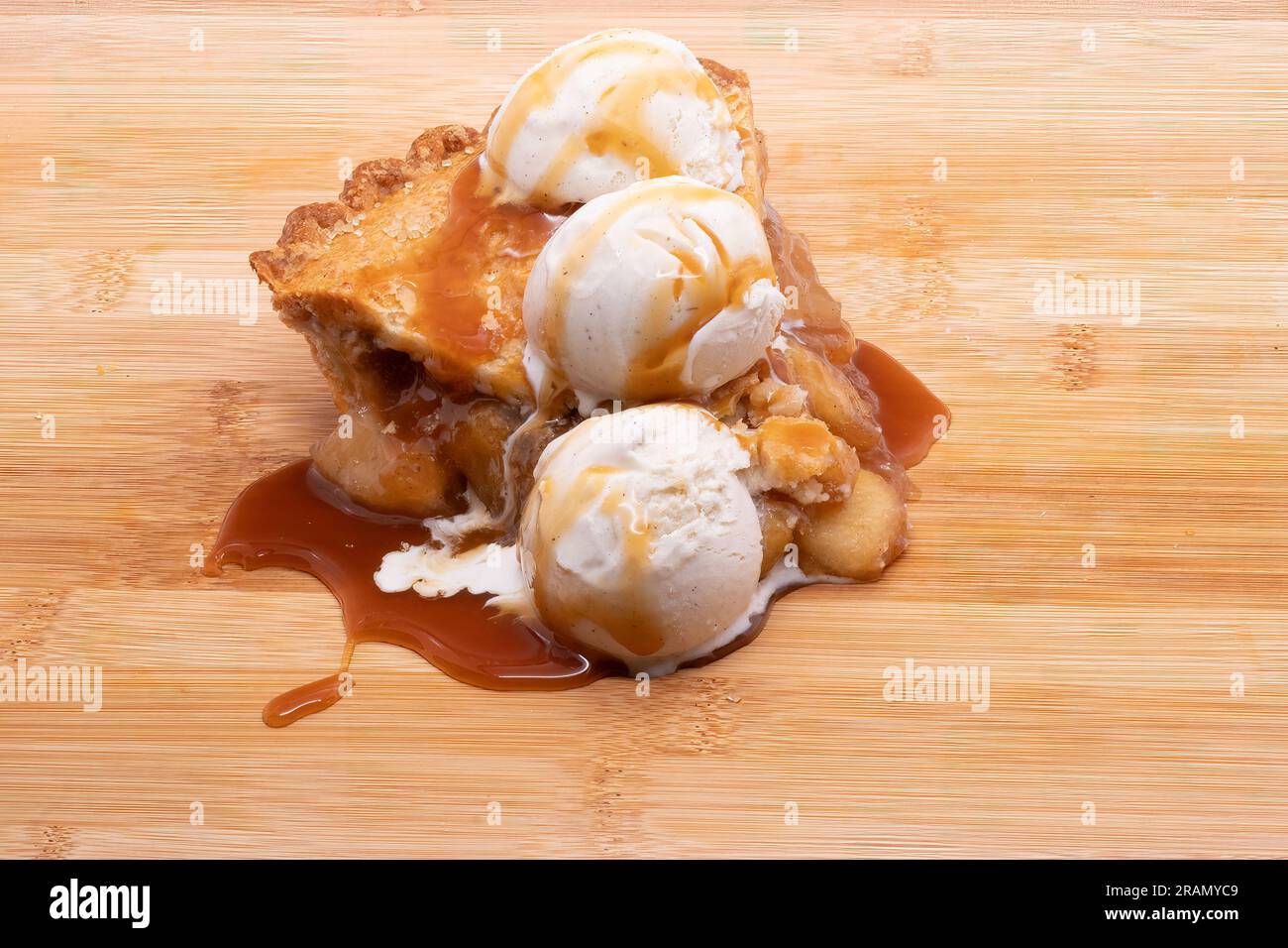 A large chunky slice of apple pie drizzled with caramel and three ...