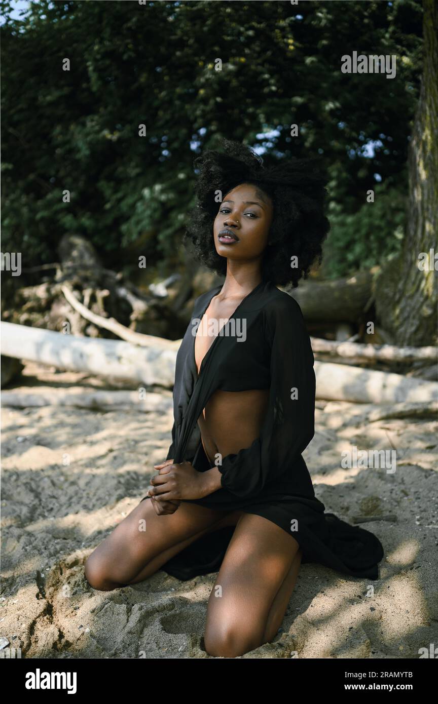 Fashion outdoor beach portrait Beautiful young African American Black woman posing outside on ...