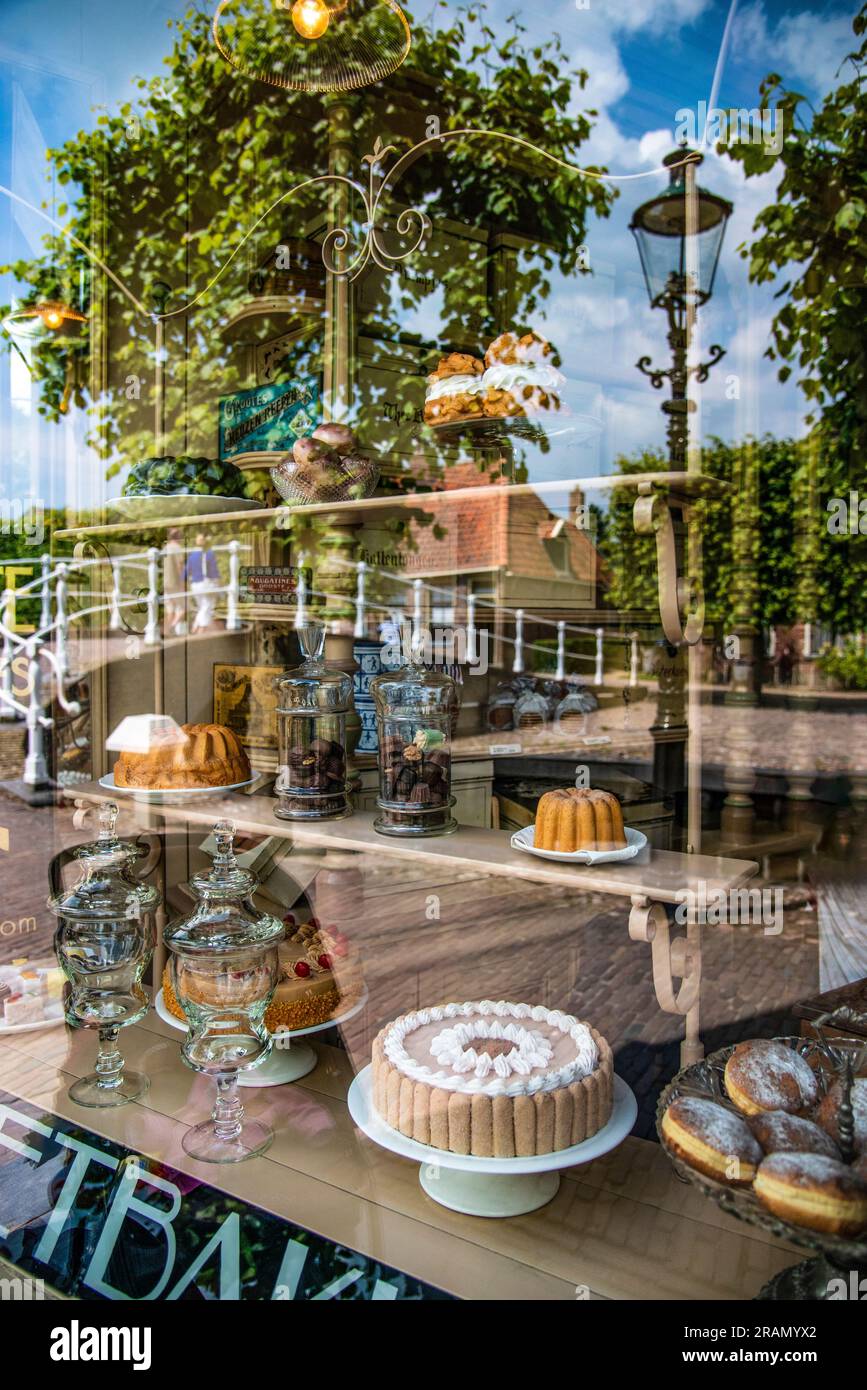bakery window with display of desserts with a reflection of the ...