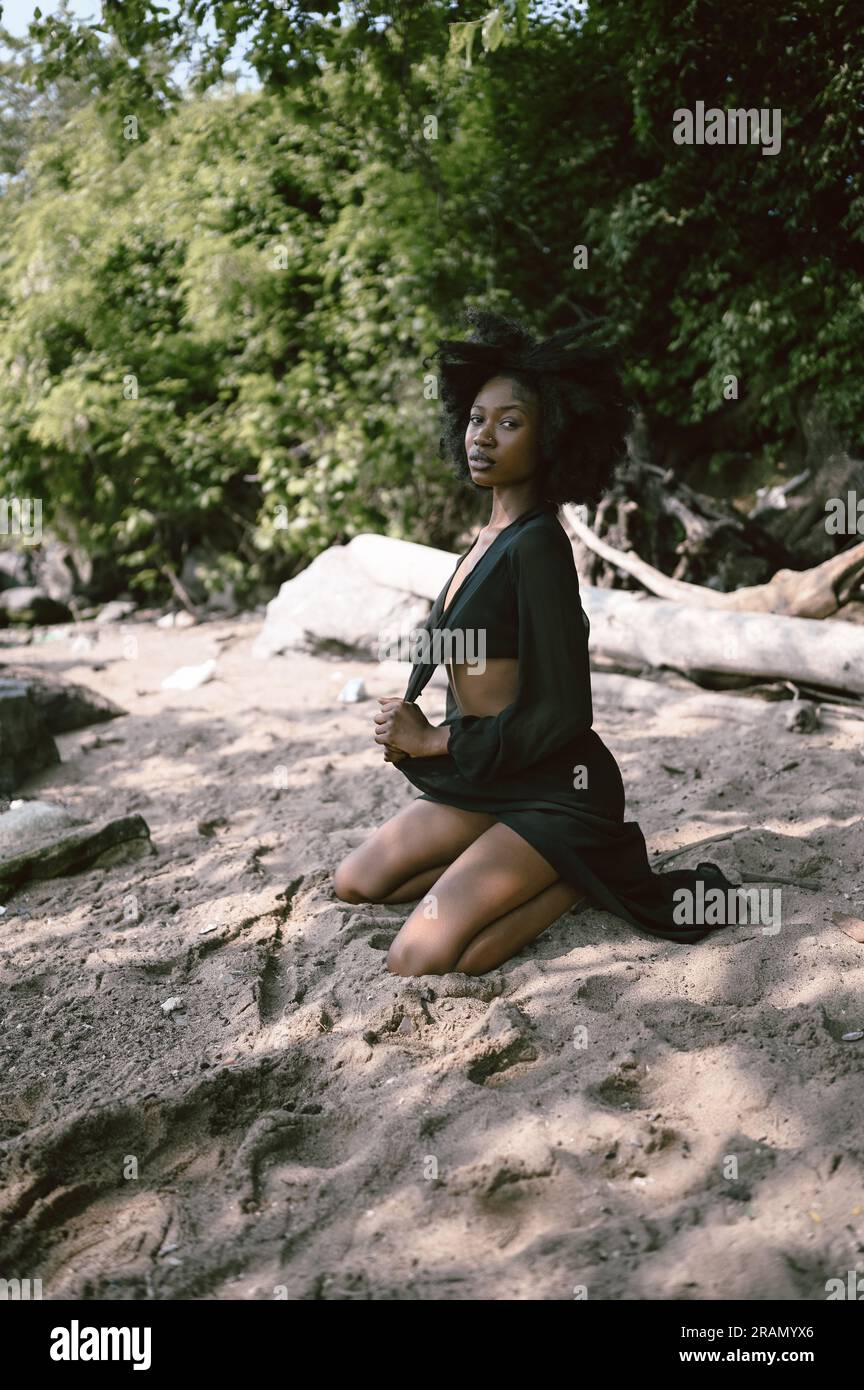 Fashion outdoor beach portrait Beautiful young African American Black woman posing outside on ...
