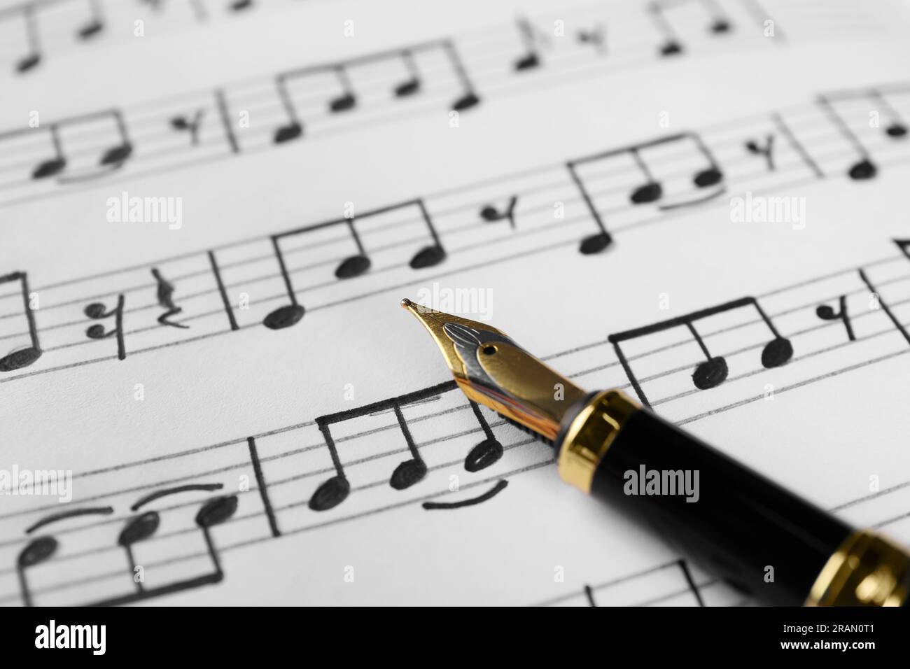 Sheet with musical notes and fountain pen, closeup view Stock Photo - Alamy