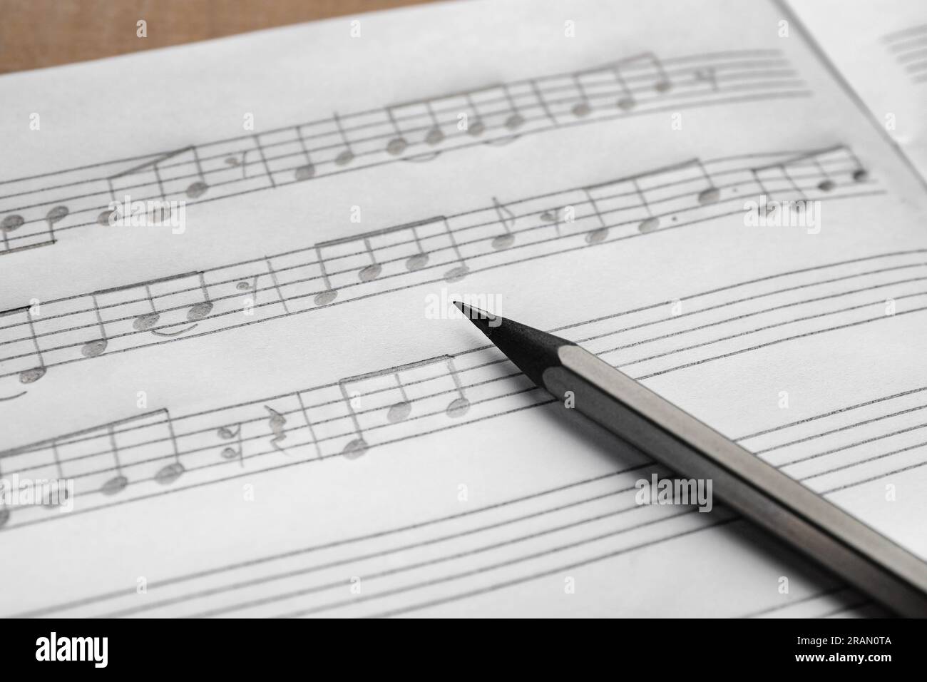 Sheet with musical notes and pencil, closeup view Stock Photo - Alamy