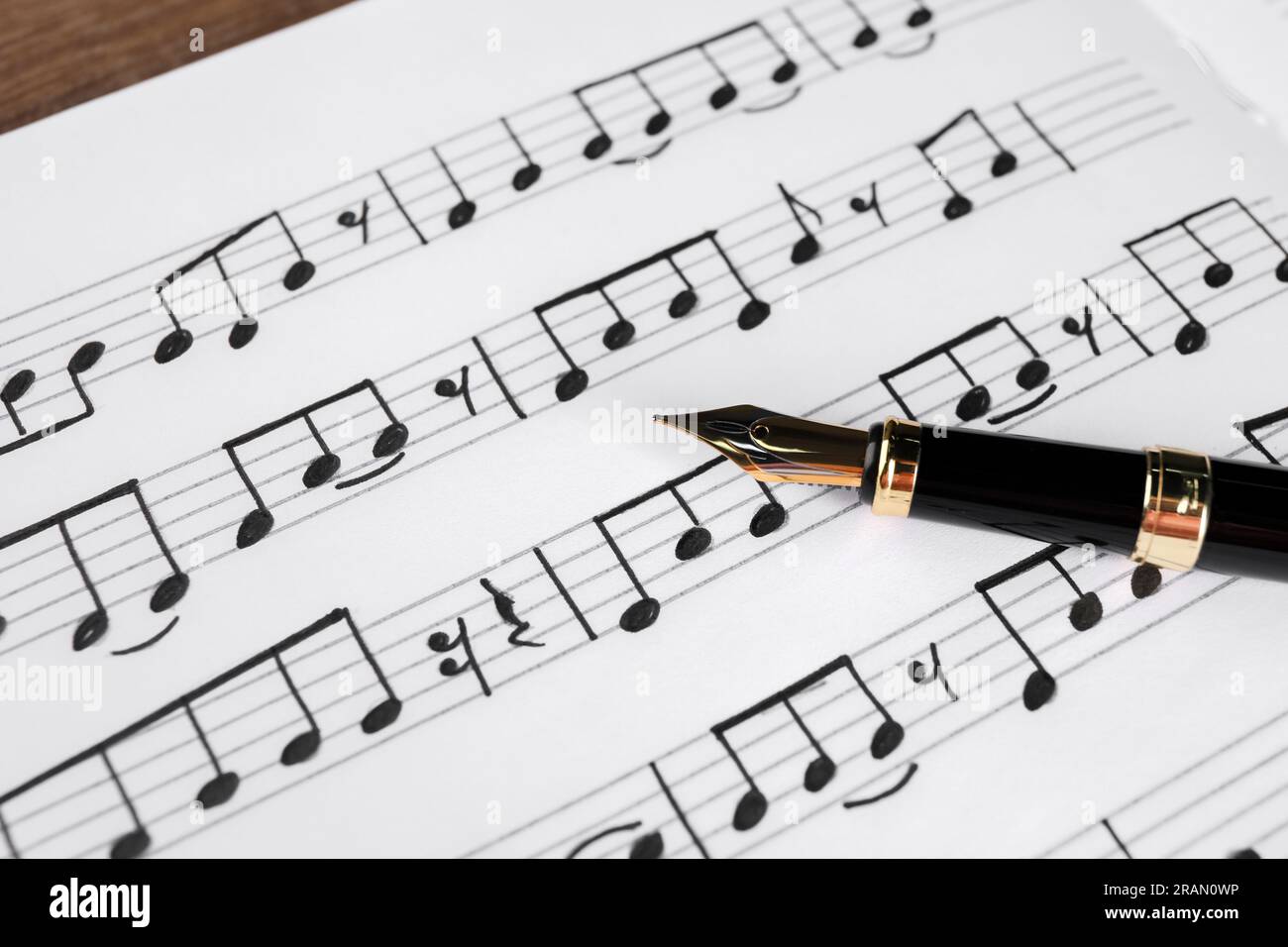 Sheet with musical notes and fountain pen, closeup view Stock Photo - Alamy