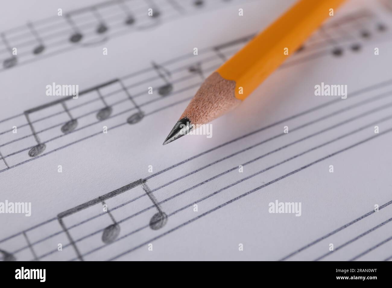 Sheet with musical notes and pencil, closeup view Stock Photo - Alamy