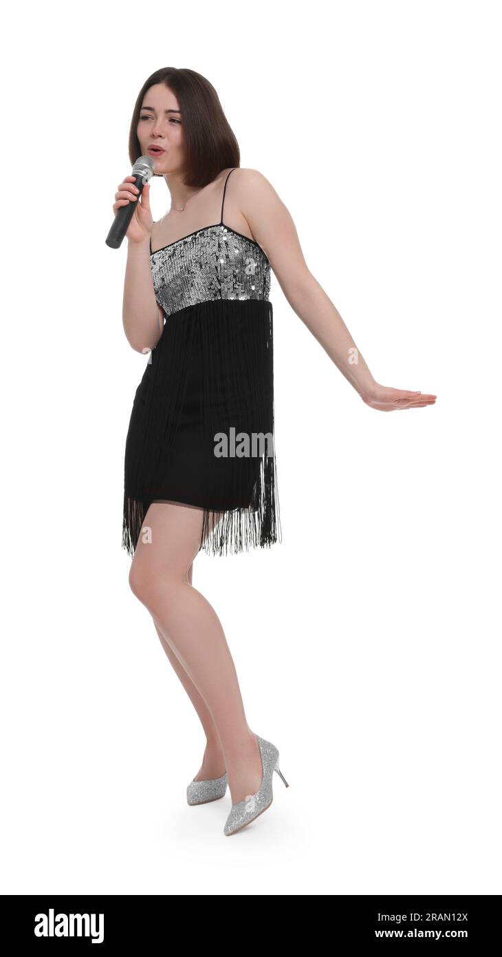 Beautiful young woman with microphone singing on white background Stock ...