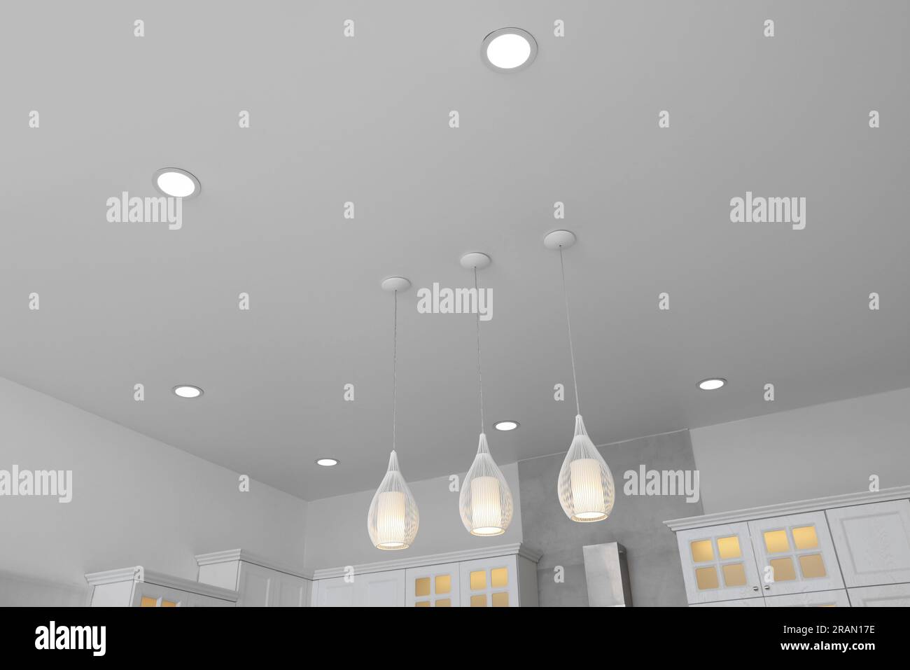 Ceiling with modern lamps and furniture in stylish kitchen, low angle ...