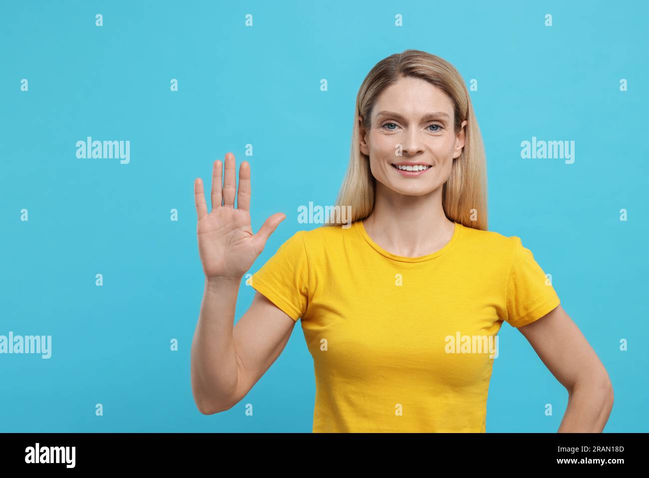 Woman giving high five on light blue background. Space for text Stock ...