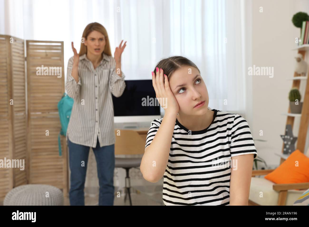 Teenage daughter ignoring mother while she scolding her at home Stock Photo - Alamy