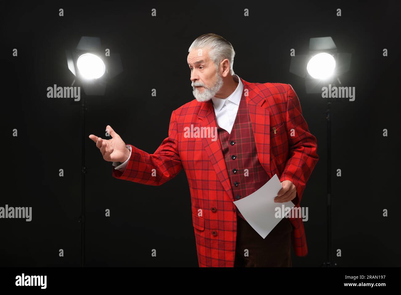 Senior actor with script performing on stage Stock Photo - Alamy