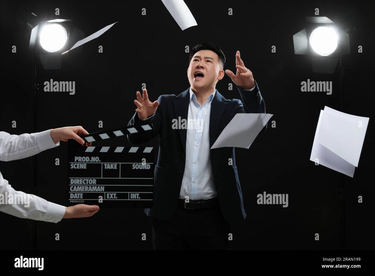 Emotional asian actor performing role while second assistant camera ...