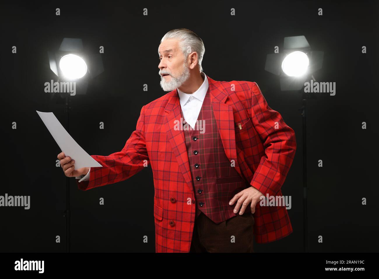 Senior actor with script performing on stage Stock Photo - Alamy