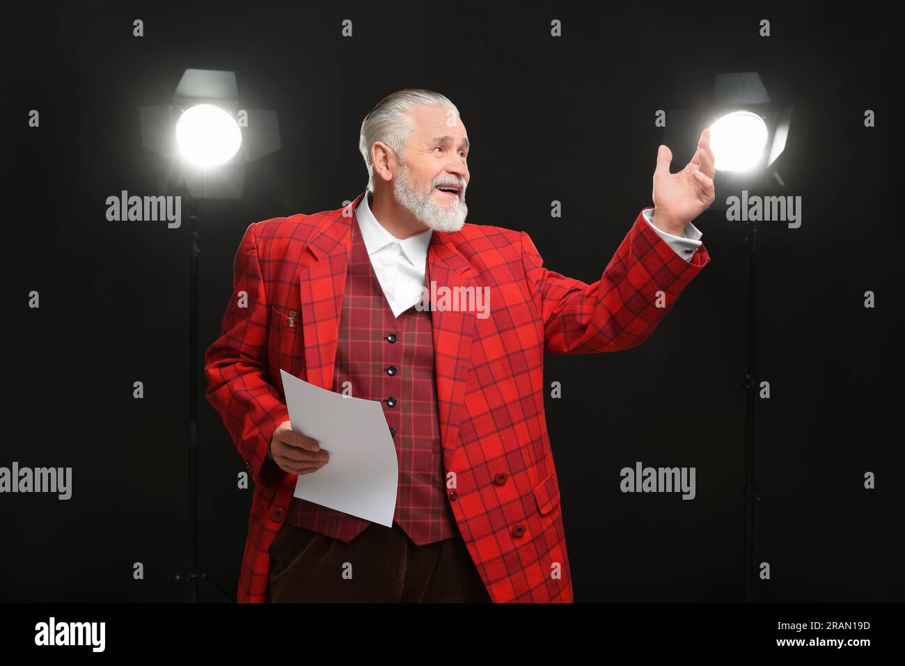 Senior actor with script performing on stage Stock Photo - Alamy