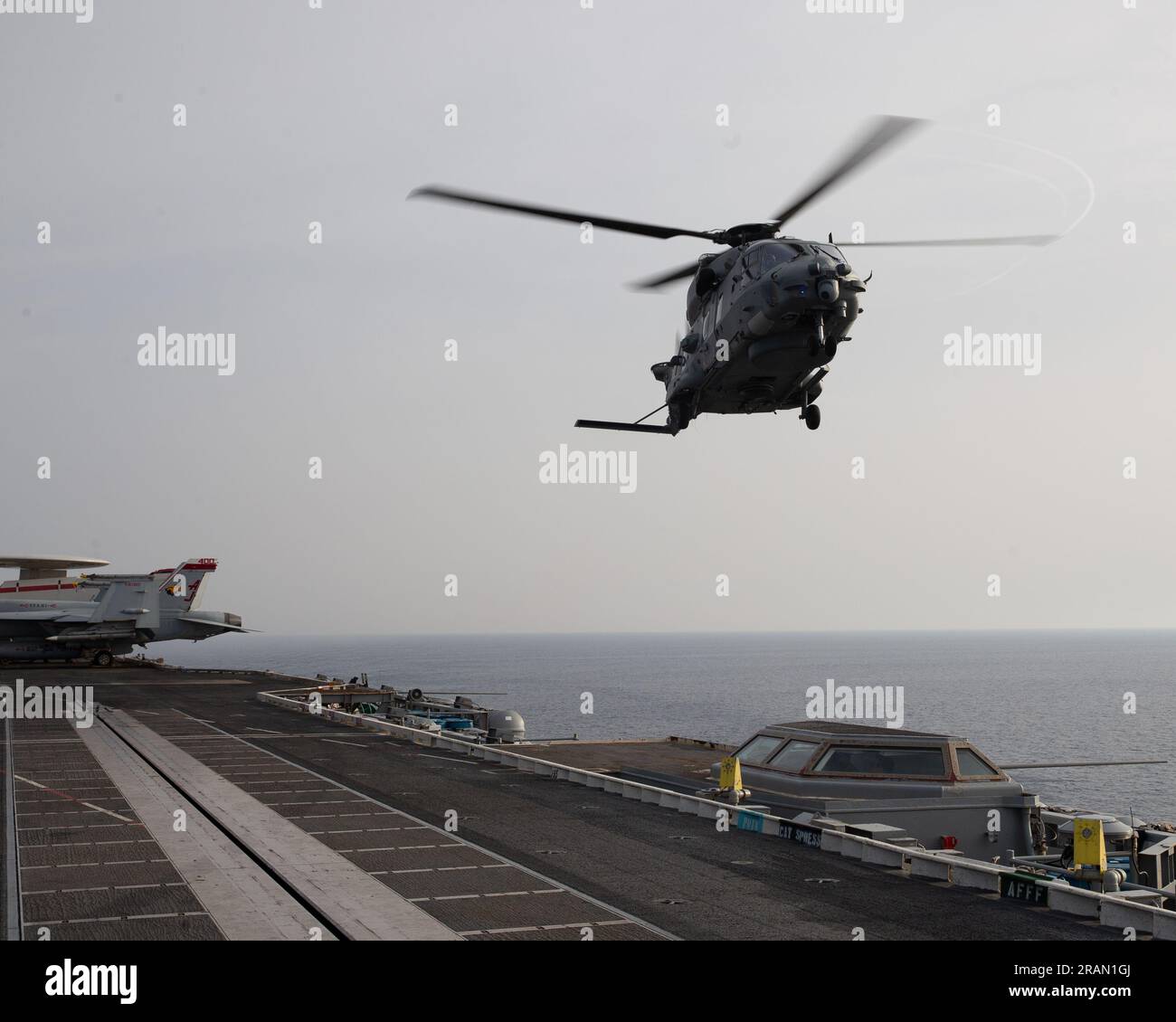An Italian Navy NH90 NATO frigate helicopter approaches the flight deck ...