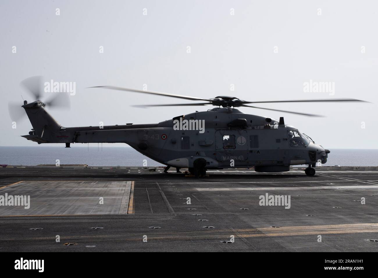 An Italian Navy NH90 NATO frigate helicopter lands on the flight deck of the worldÕs largest ...