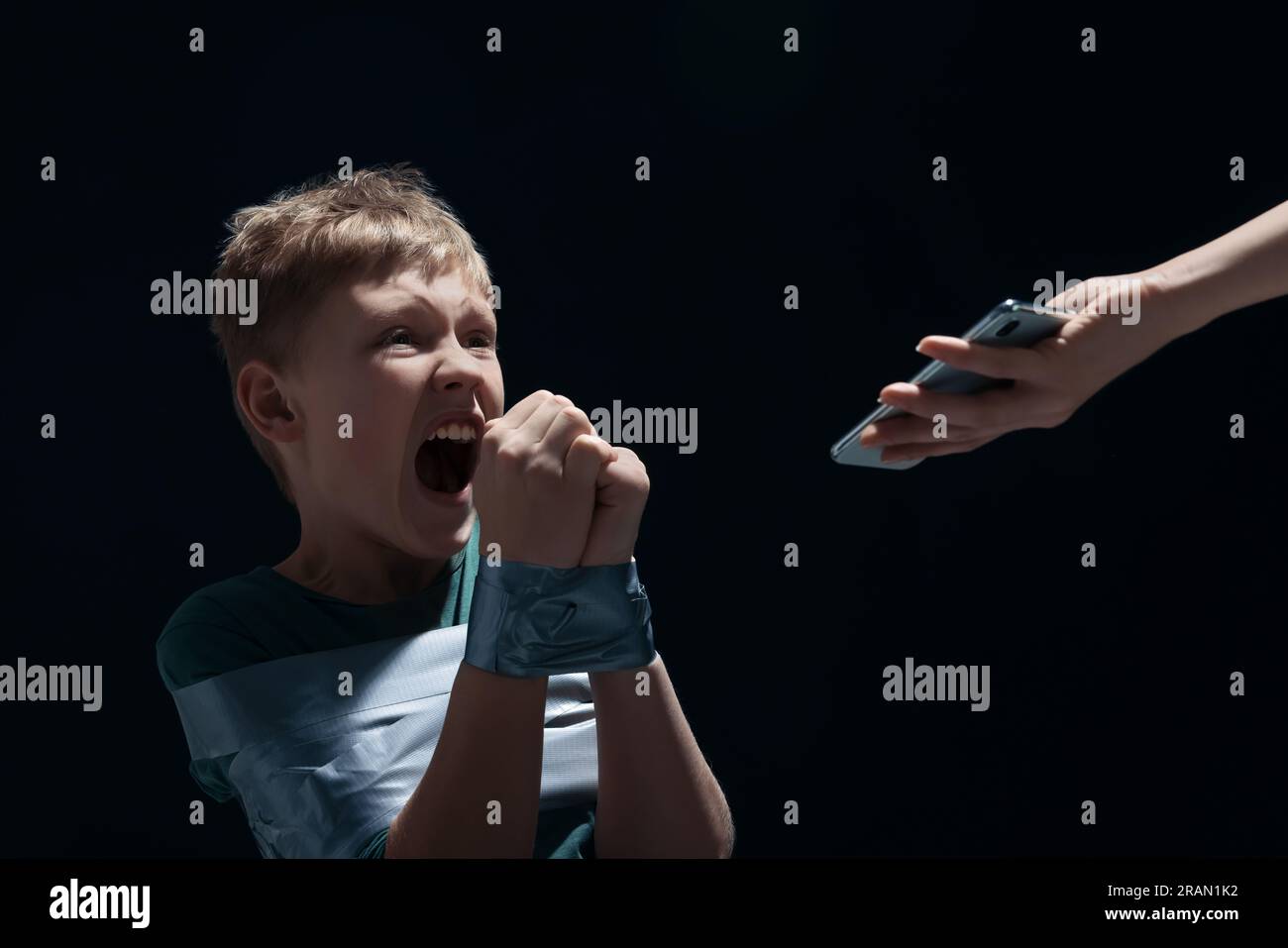 Kidnapper with phone near scarred little boy taken hostage on dark ...