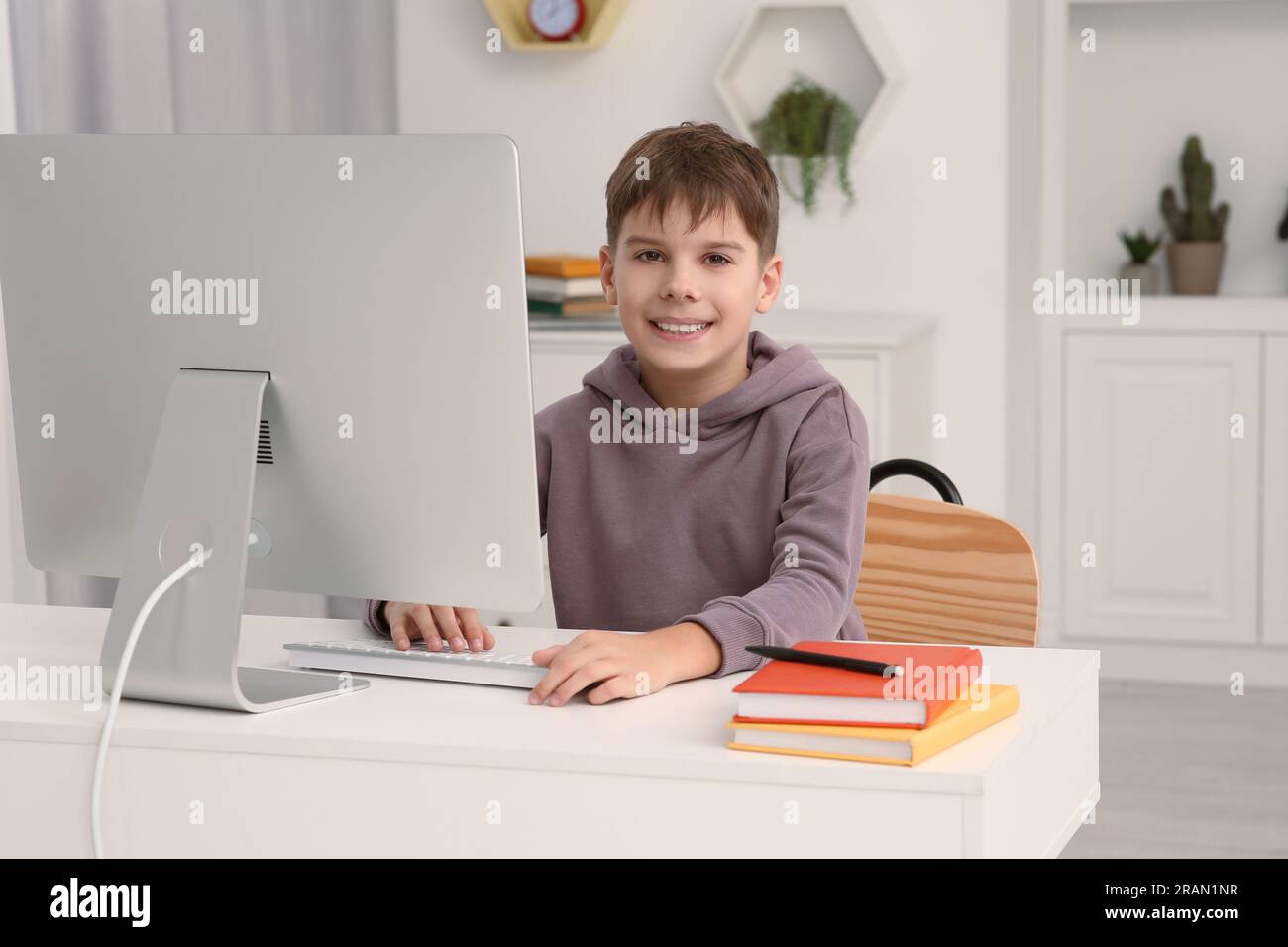 Boy studying computer books hi-res stock photography and images - Alamy