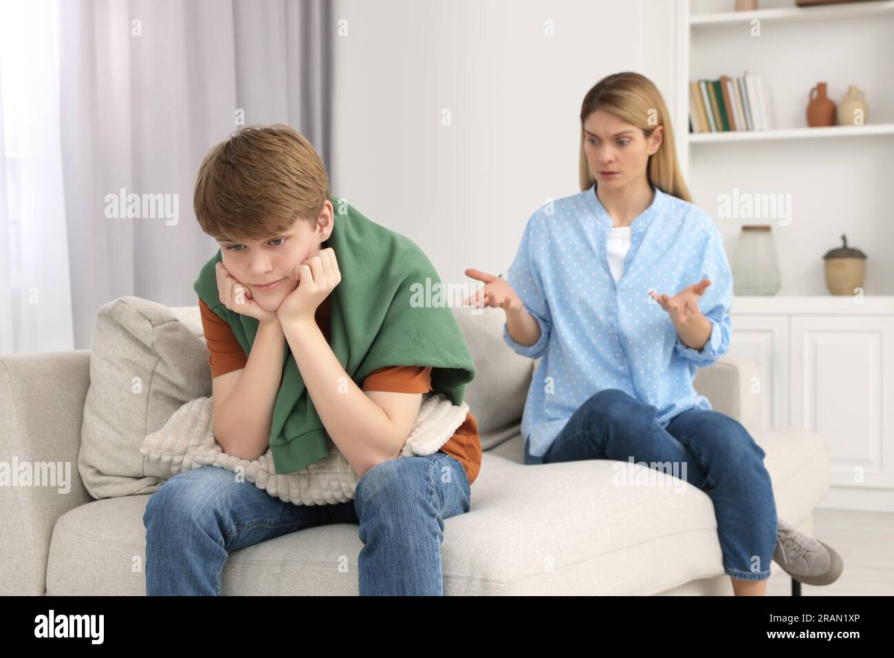 Teenage son ignoring mother while she scolding him at home Stock Photo ... Teenage son ignoring mother while she scolding him at home Stock Photo ...