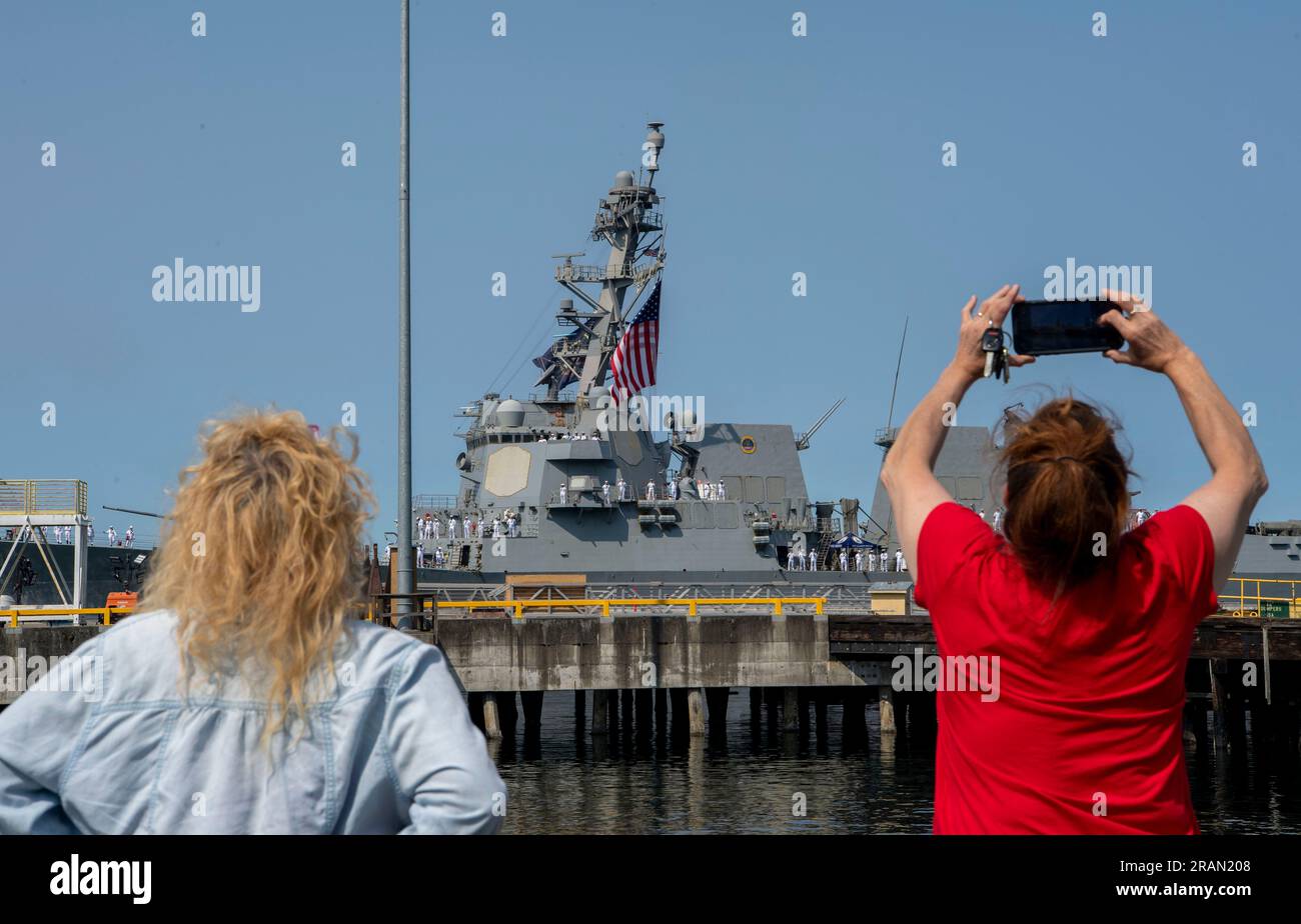 Spectators watch and take photos as the Arleigh Burke-class guided ...