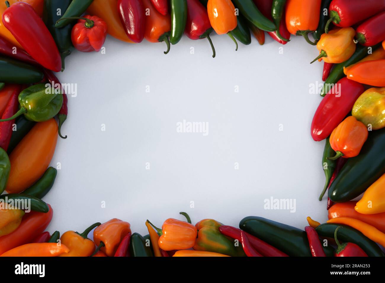 Frame of chili peppers on white background, flat lay. Space for text ...