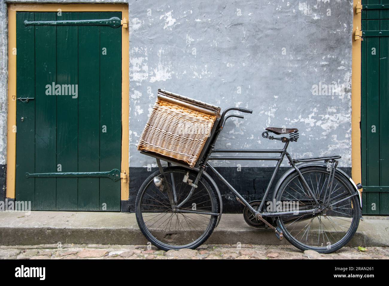 old one gear black Dutch bicycle with large woven basket Stock Photo ...