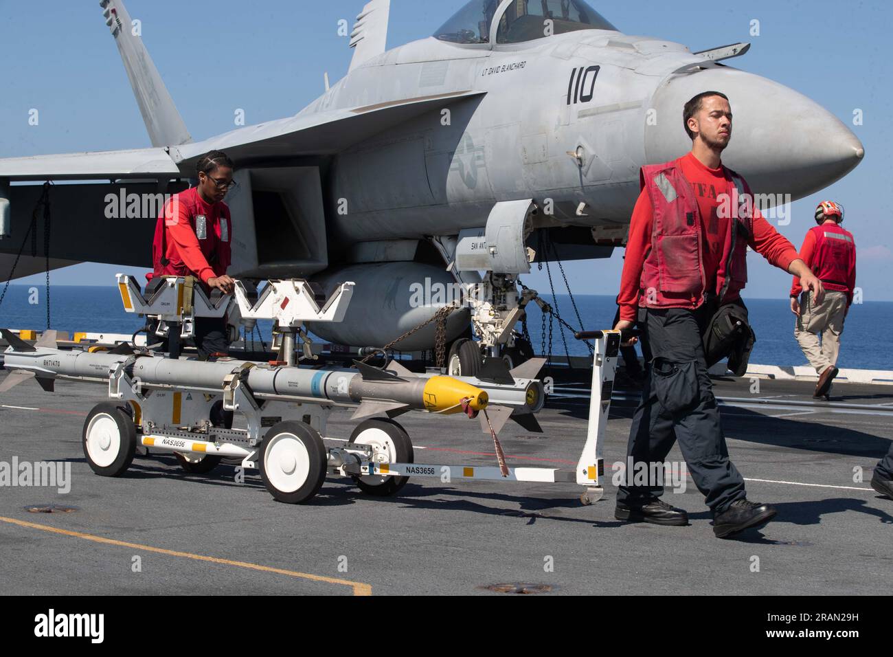 Sailors assigned to the “Ragin Bulls” of Strike Fighter Squadron (VFA) 37, transport ammunition ...