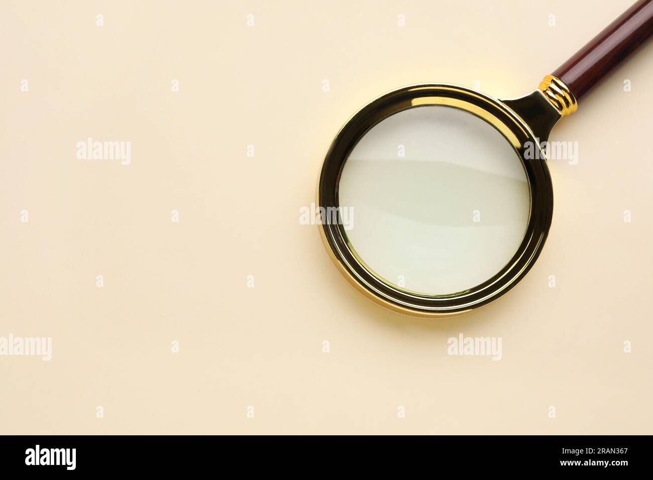 Magnifying glass on beige background, top view. Space for text Stock ...
