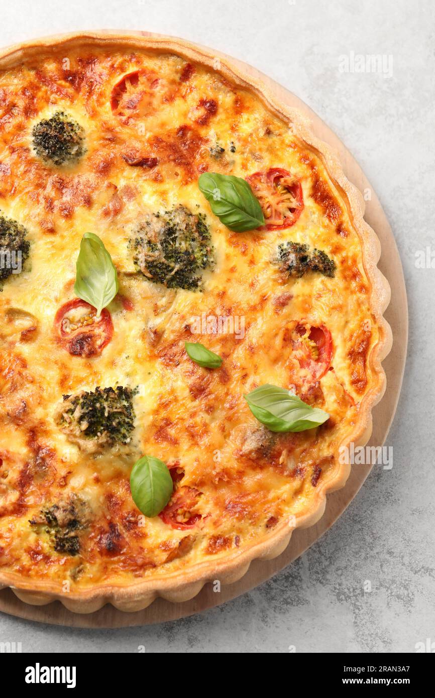 Delicious homemade vegetable quiche on light gray table, top view Stock ...