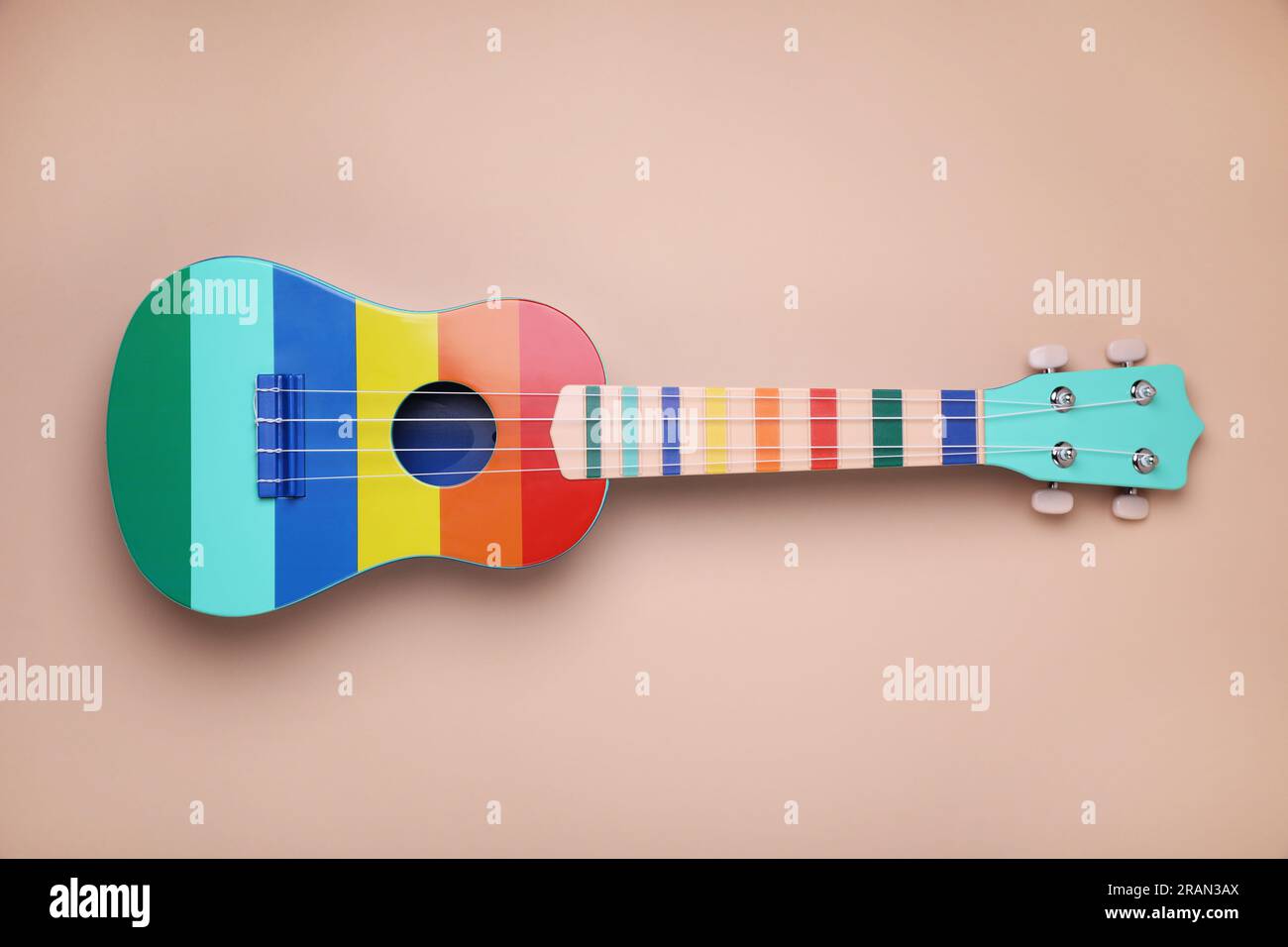 Colorful ukulele on beige background, top view. String musical ...