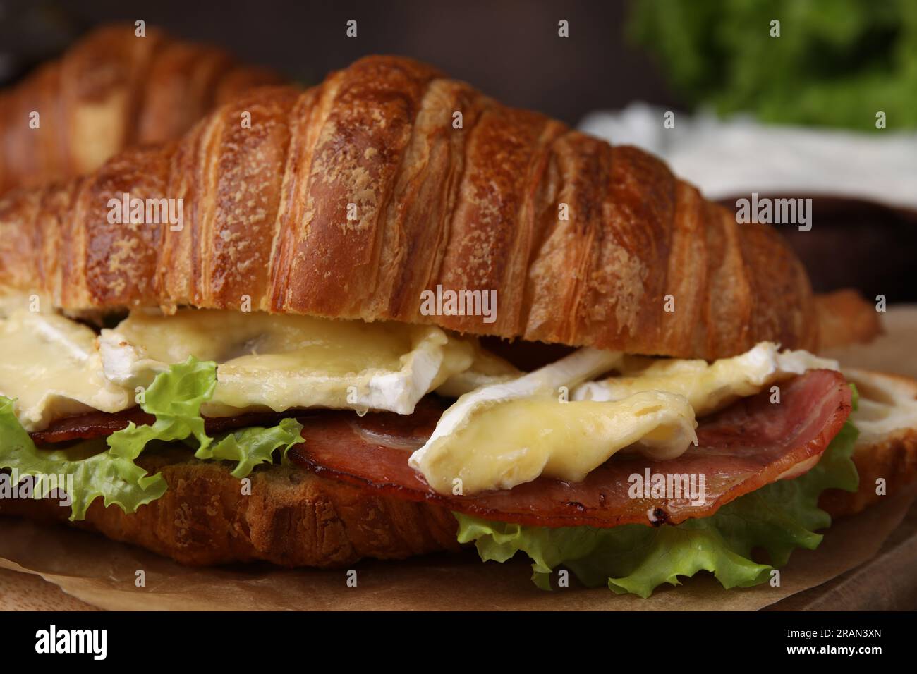 Tasty croissant with brie cheese and bacon, closeup Stock Photo - Alamy