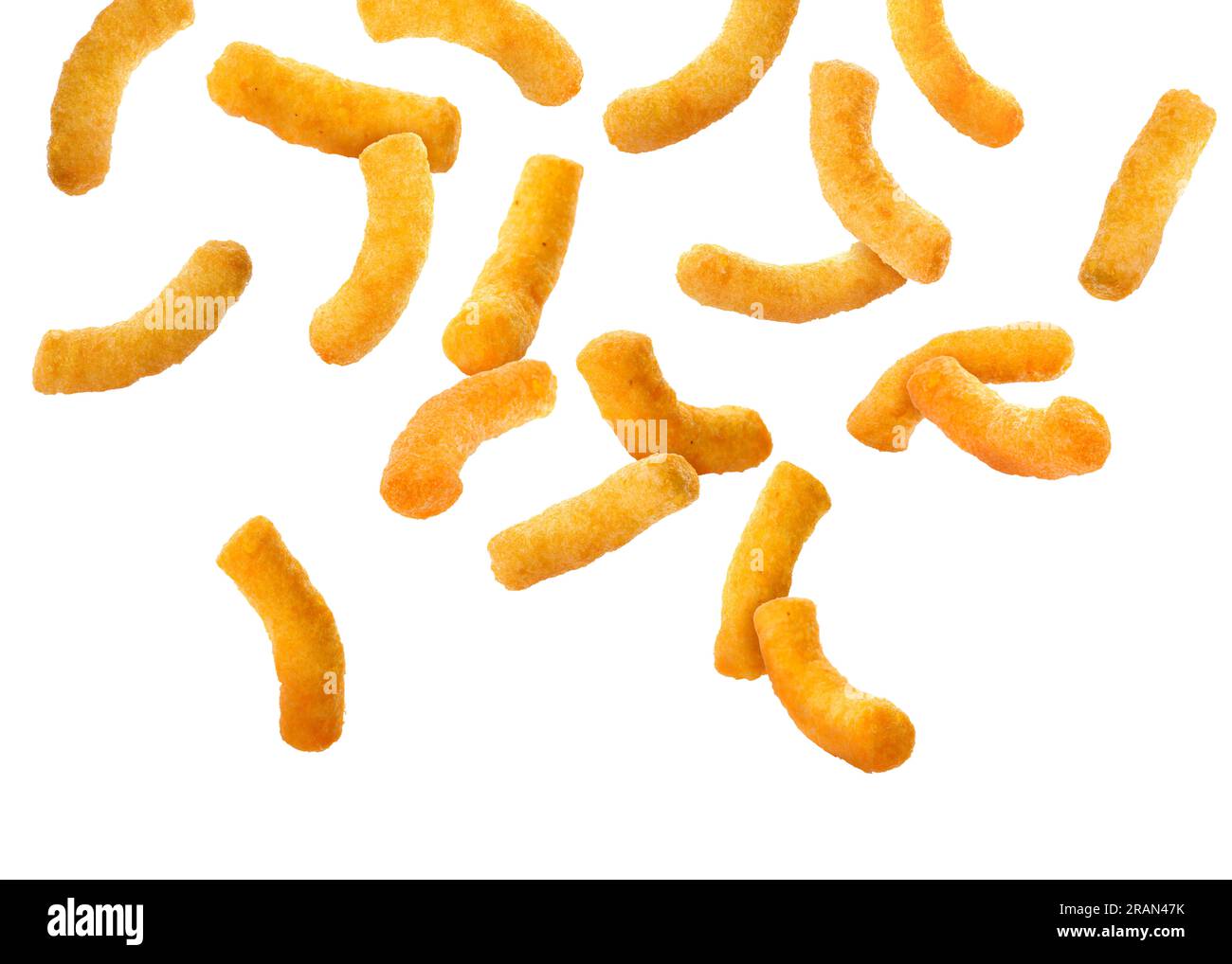Many tasty corn sticks falling on white background Stock Photo - Alamy