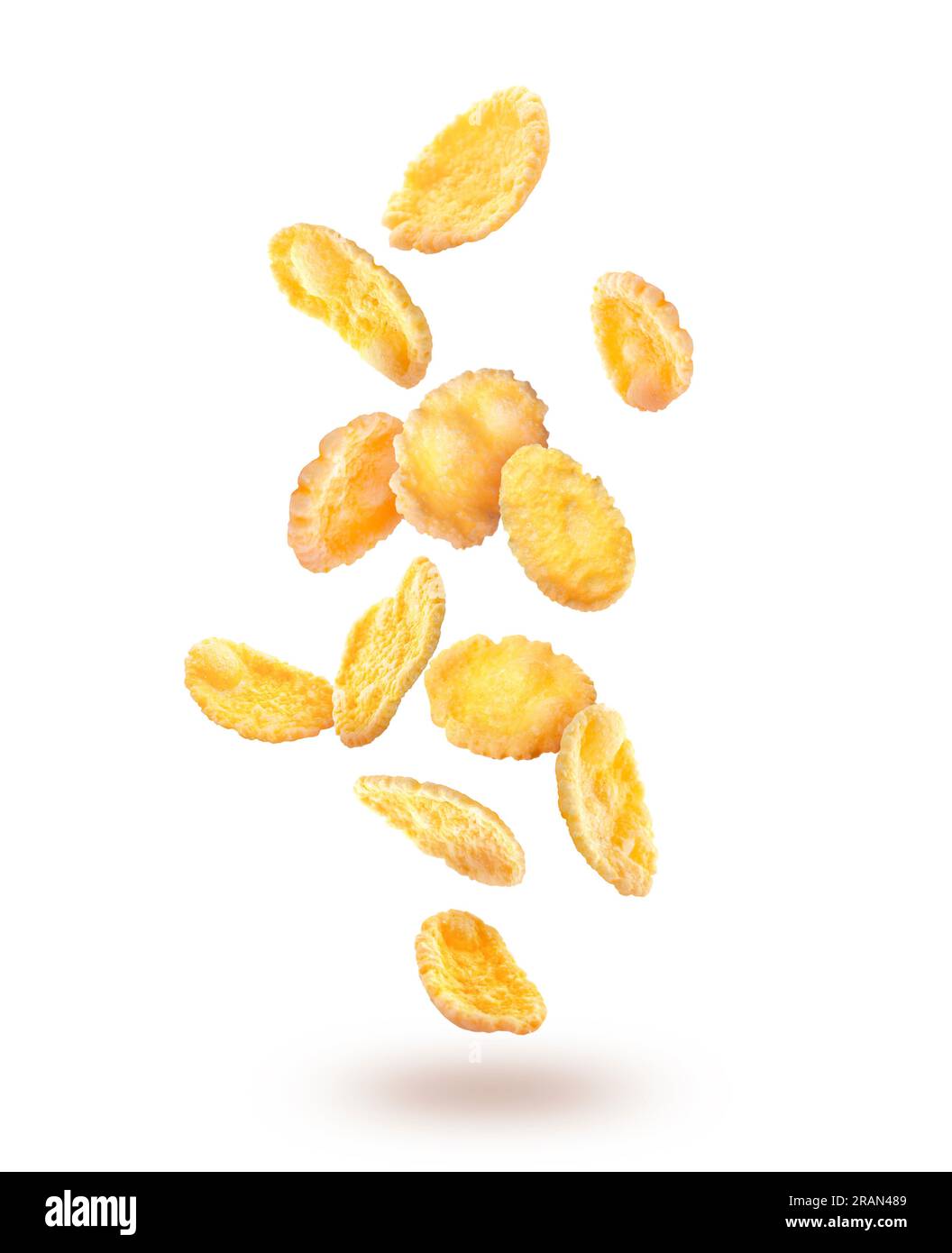 Golden corn flakes falling on white background Stock Photo - Alamy