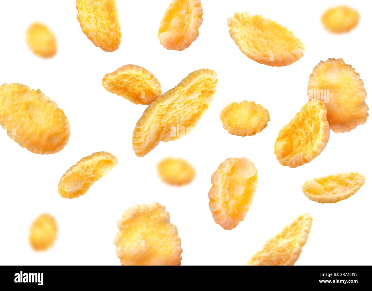 Golden corn flakes falling on white background Stock Photo - Alamy