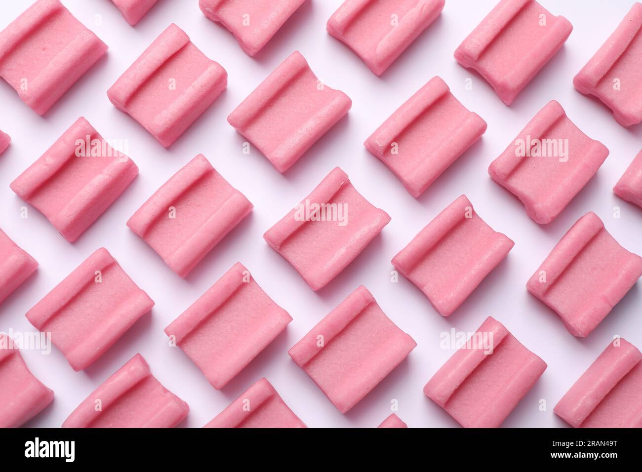 Tasty pink chewing gums on white background, flat lay Stock Photo - Alamy