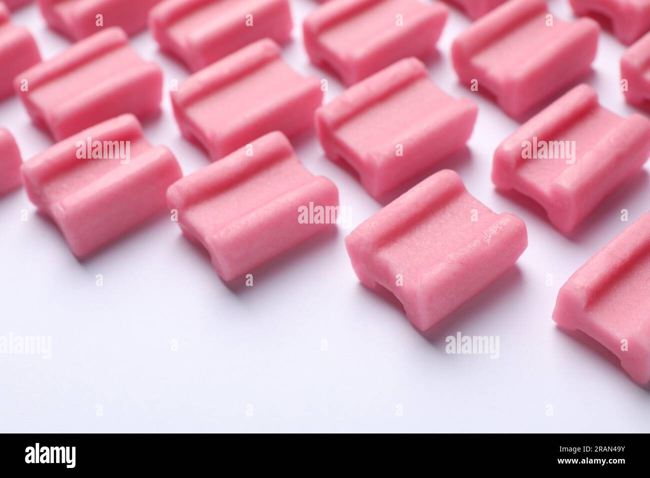 Tasty pink chewing gums on white background, closeup Stock Photo - Alamy