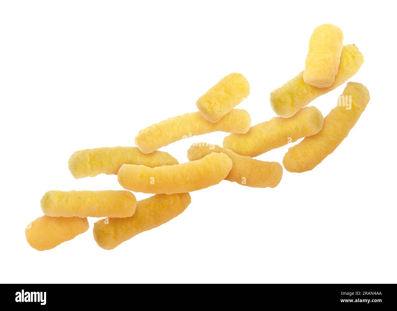 Many tasty corn sticks falling on white background Stock Photo - Alamy